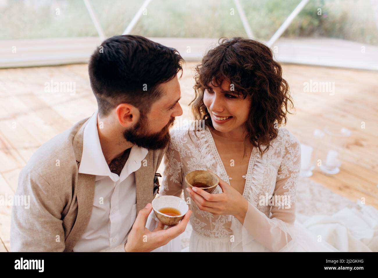 Tea ceremony at a boho wedding. Bride and groom in boho Stock Photo - Alamy