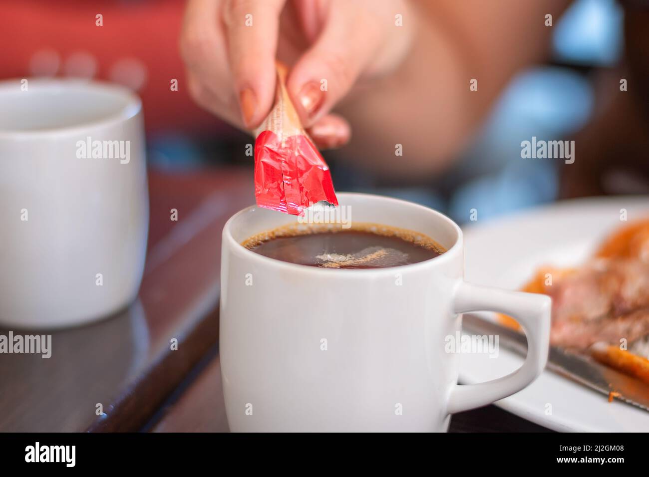 white cup with hot coffee drink with powder ingredient sachet Stock ...