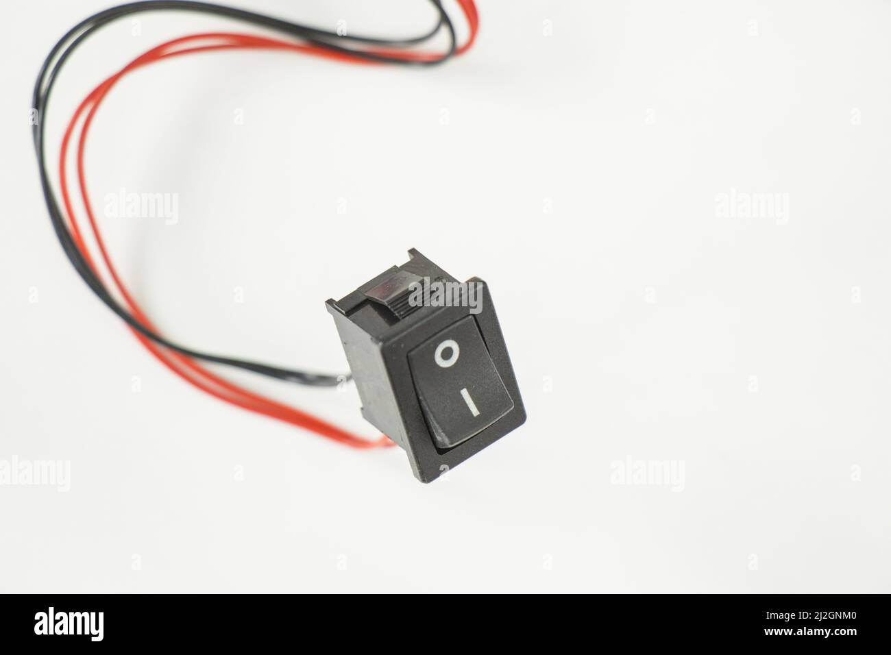 The on and off button with red and black wires isolated on a white ...