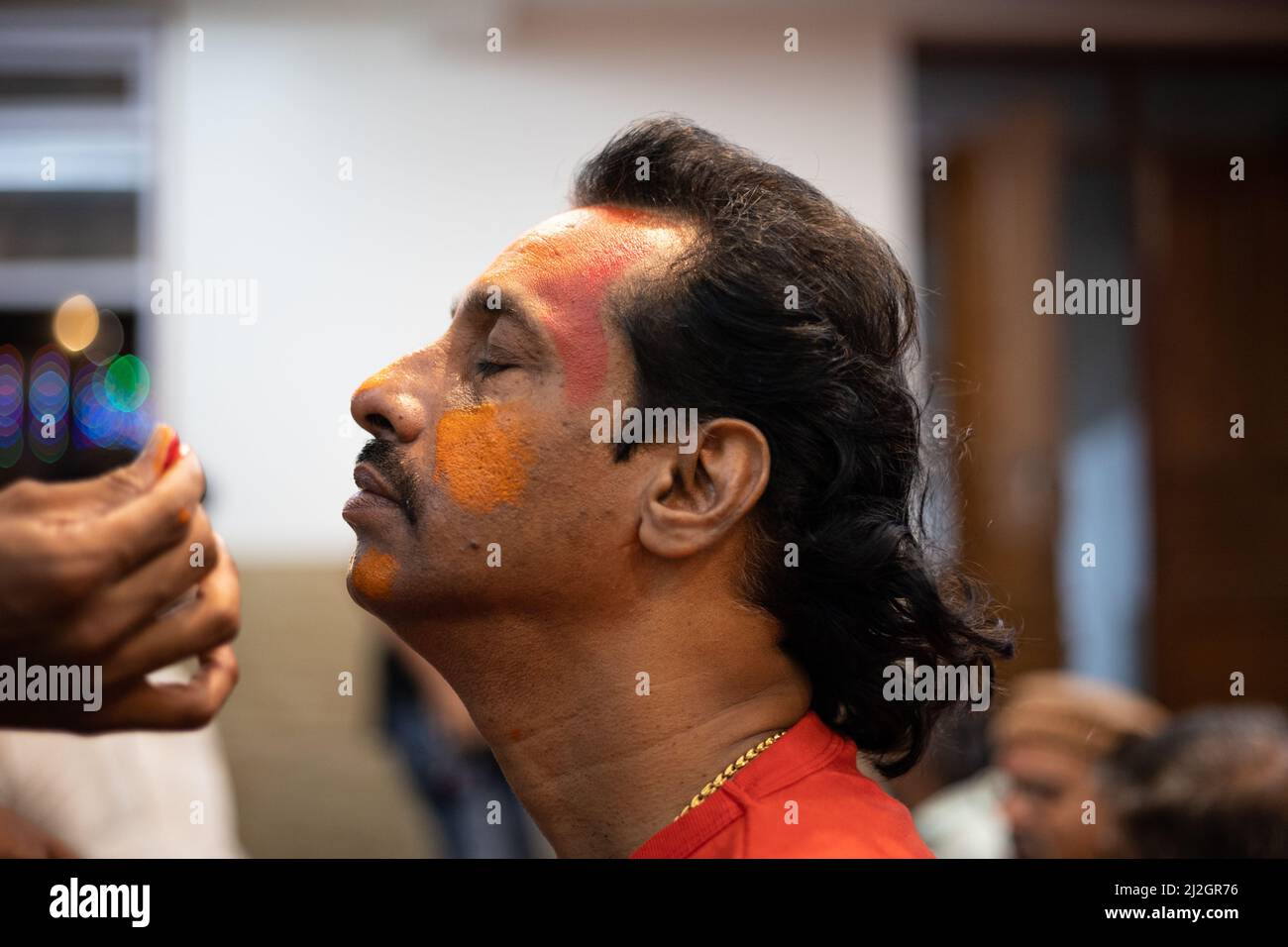 Artist painting the face of a man to get him ready as Virabhadra for ...