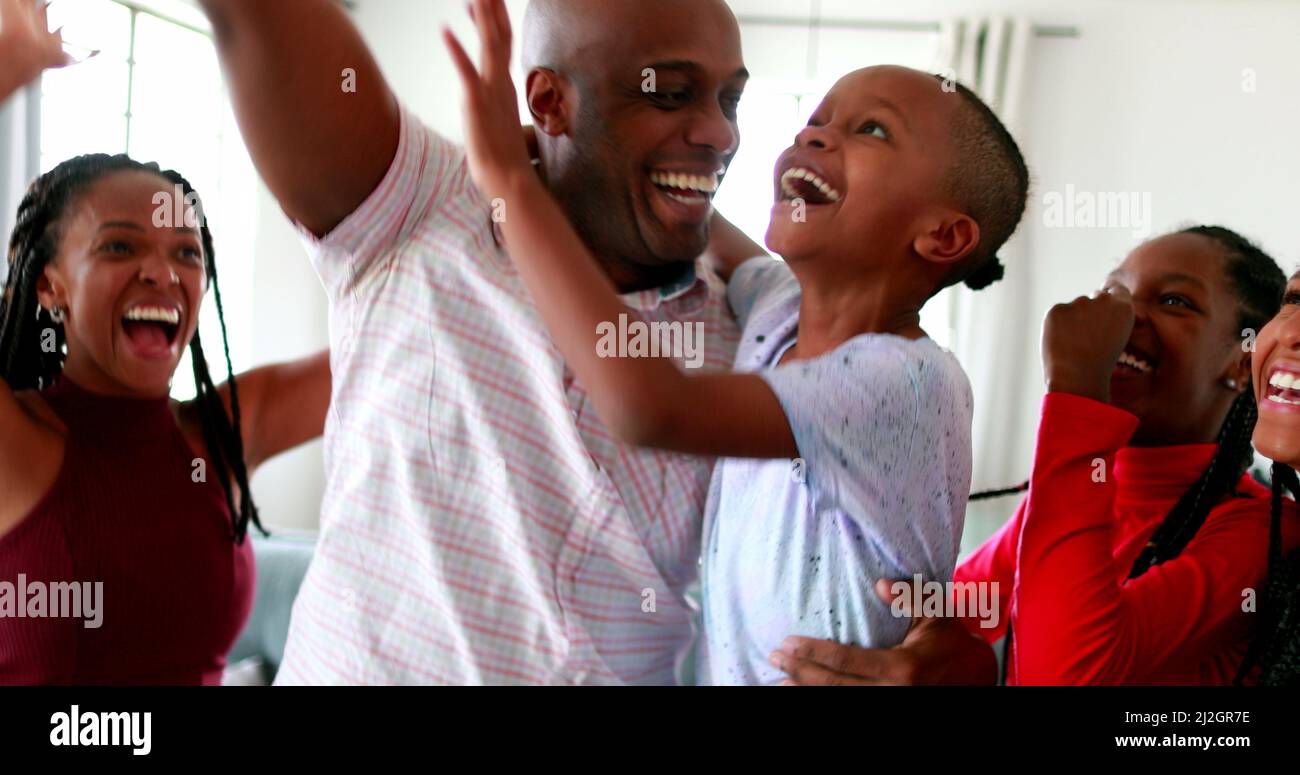 African family celebrating success cheering holding cellphone device ...