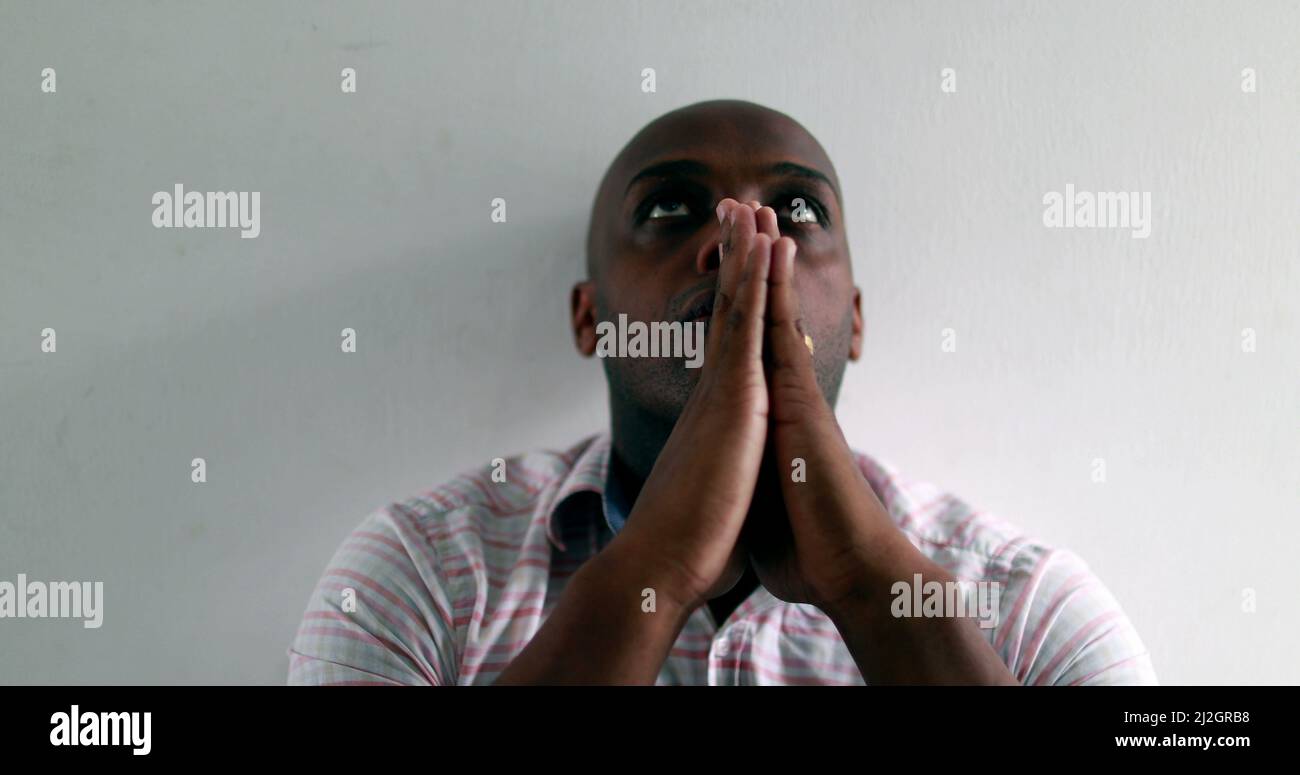 African man praying to God during difficult times Stock Photo - Alamy