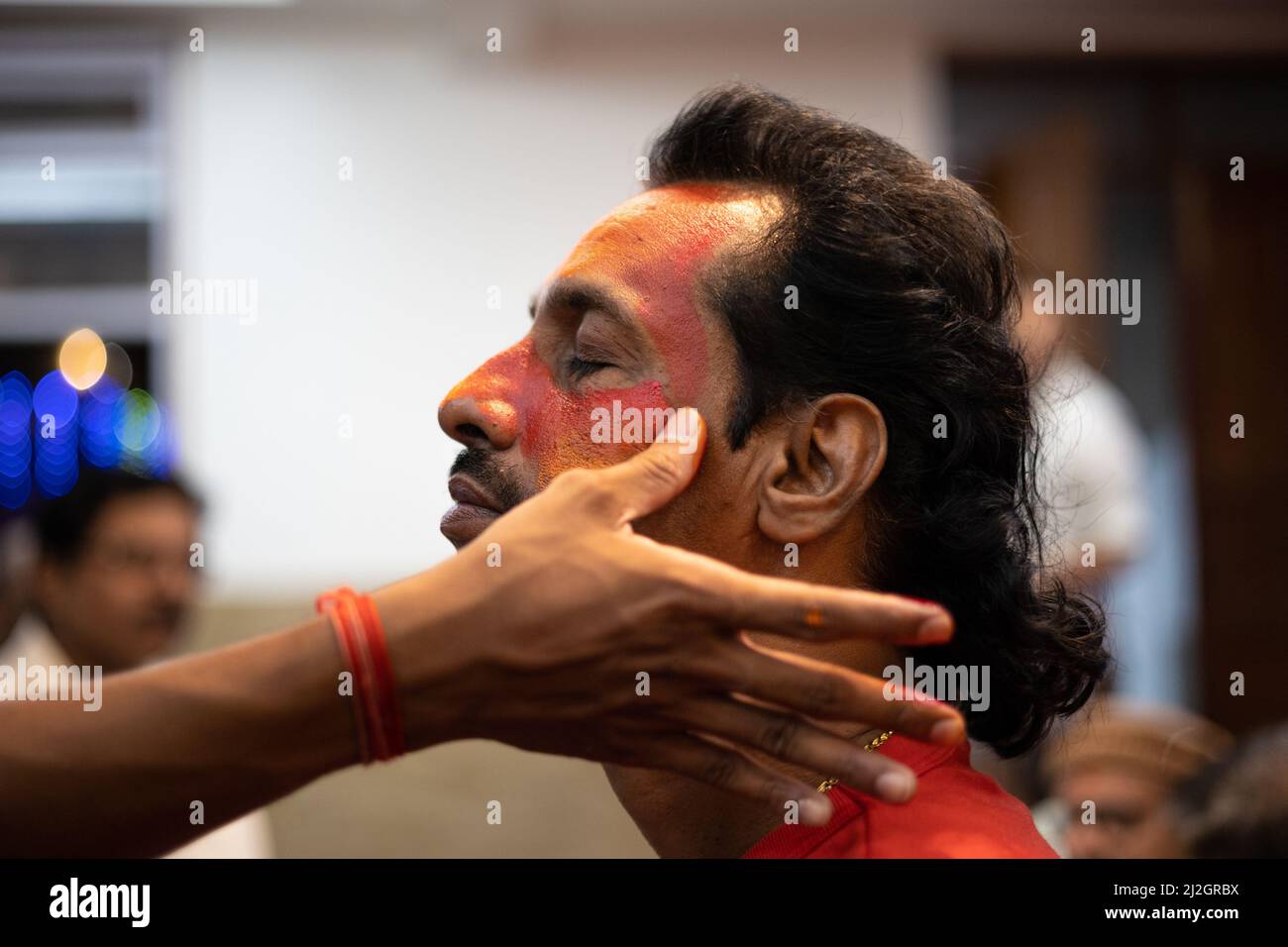 Artist painting the face of a man to get him ready as Virabhadra for ...