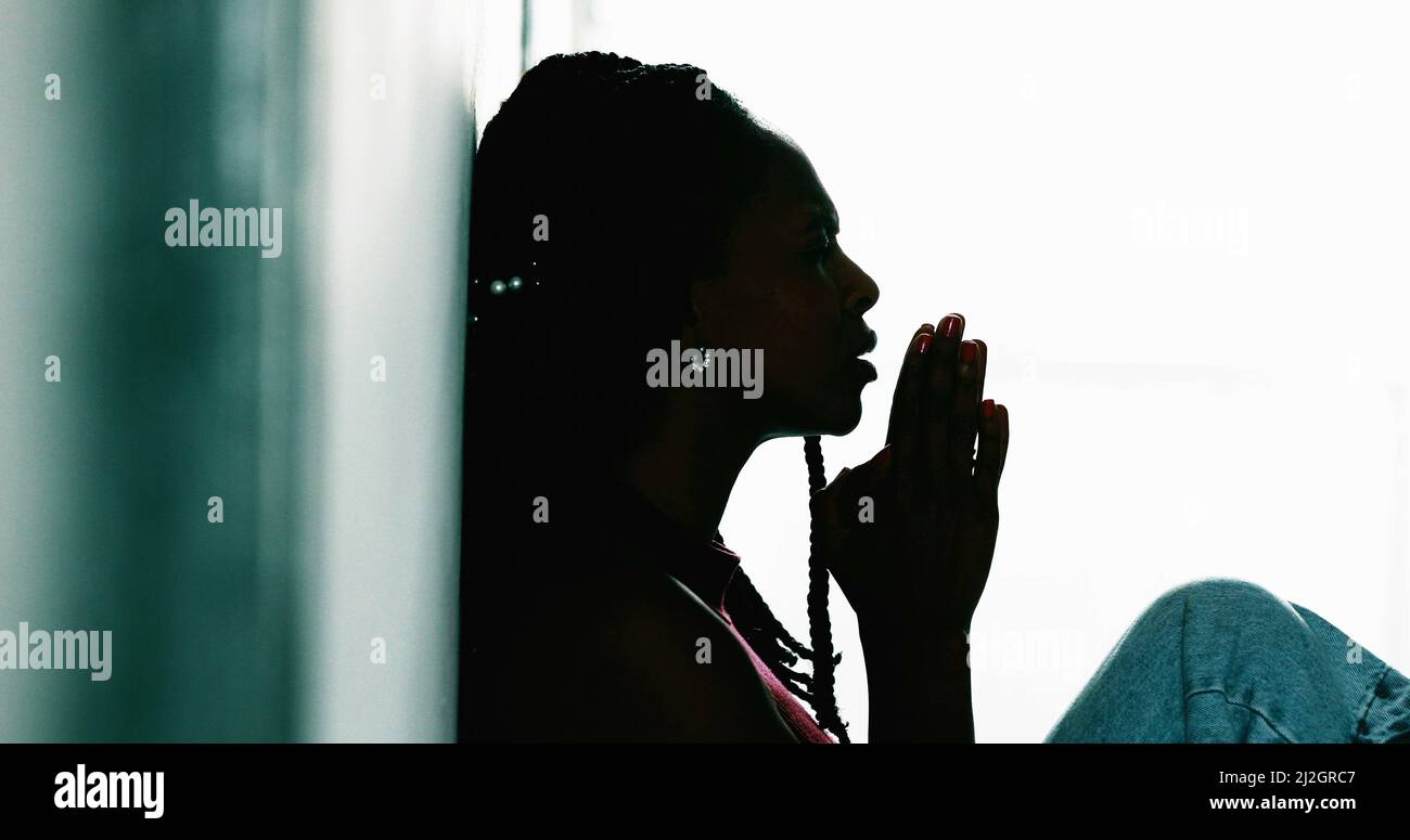 African woman praying with HOPE and FAITH2 Stock Photo - Alamy