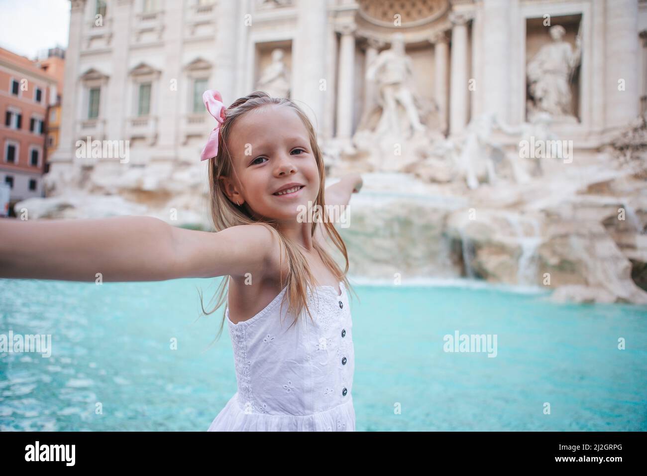 Adorable little girl background Trevi Fountain, Rome, Italy. Happy ...