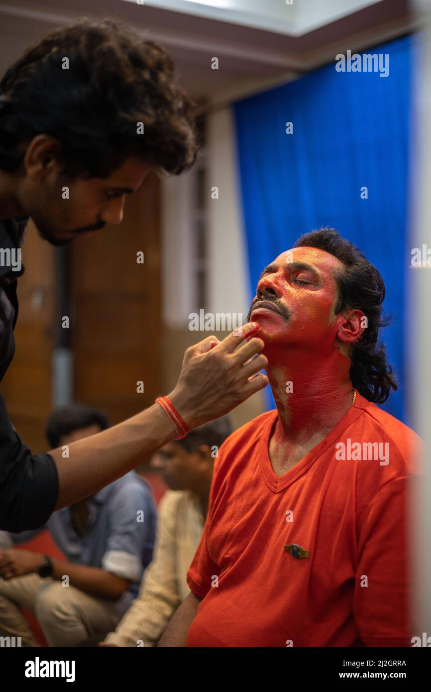 Artist painting the face of a man to get him ready as Virabhadra for ...
