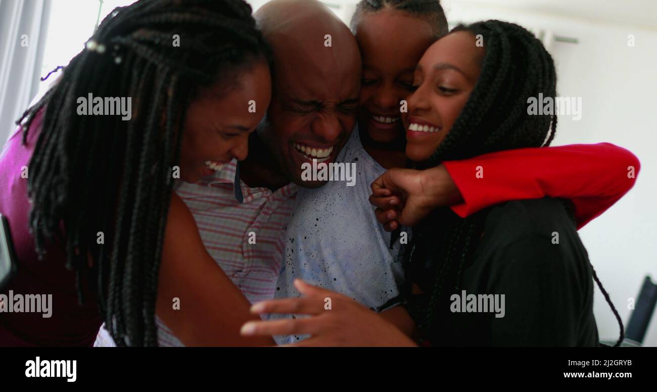 Family hug love and embrace. African ethnicity loving parents and ...