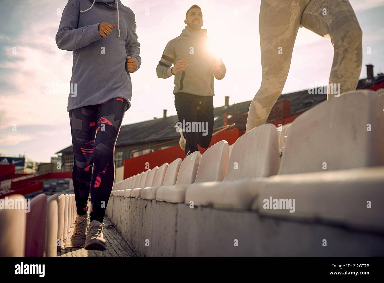 Group of athletes running together on the bleachers Stock Photo - Alamy