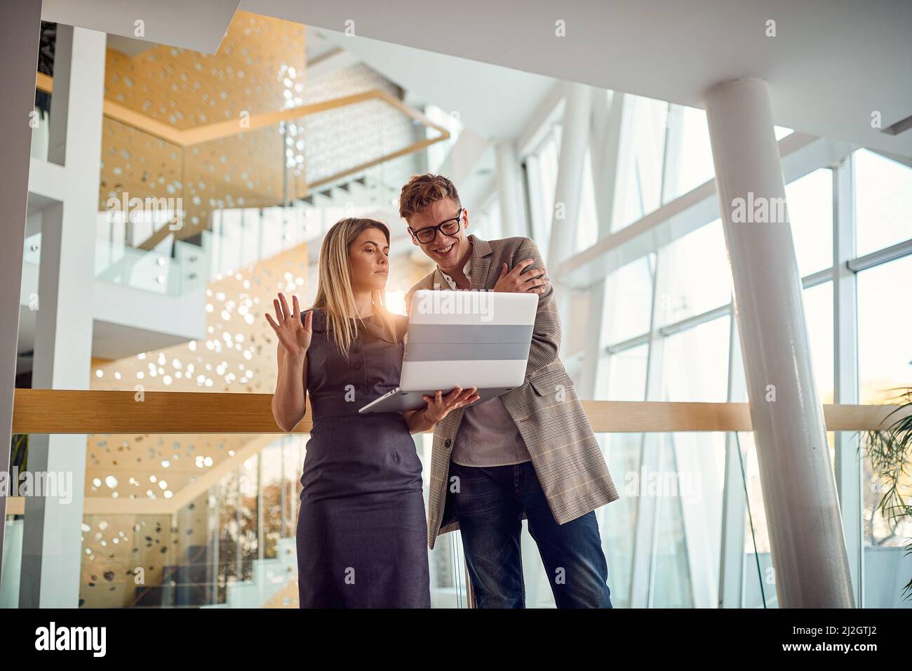 Shot from below of young handsome business colleagues standing in a ...