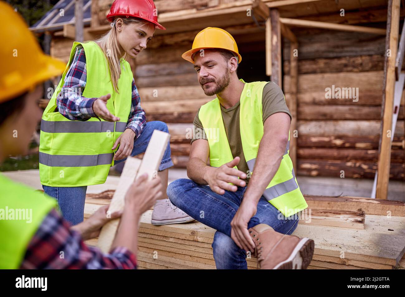 Builders are talking at the cottage construction site in the forest on ...