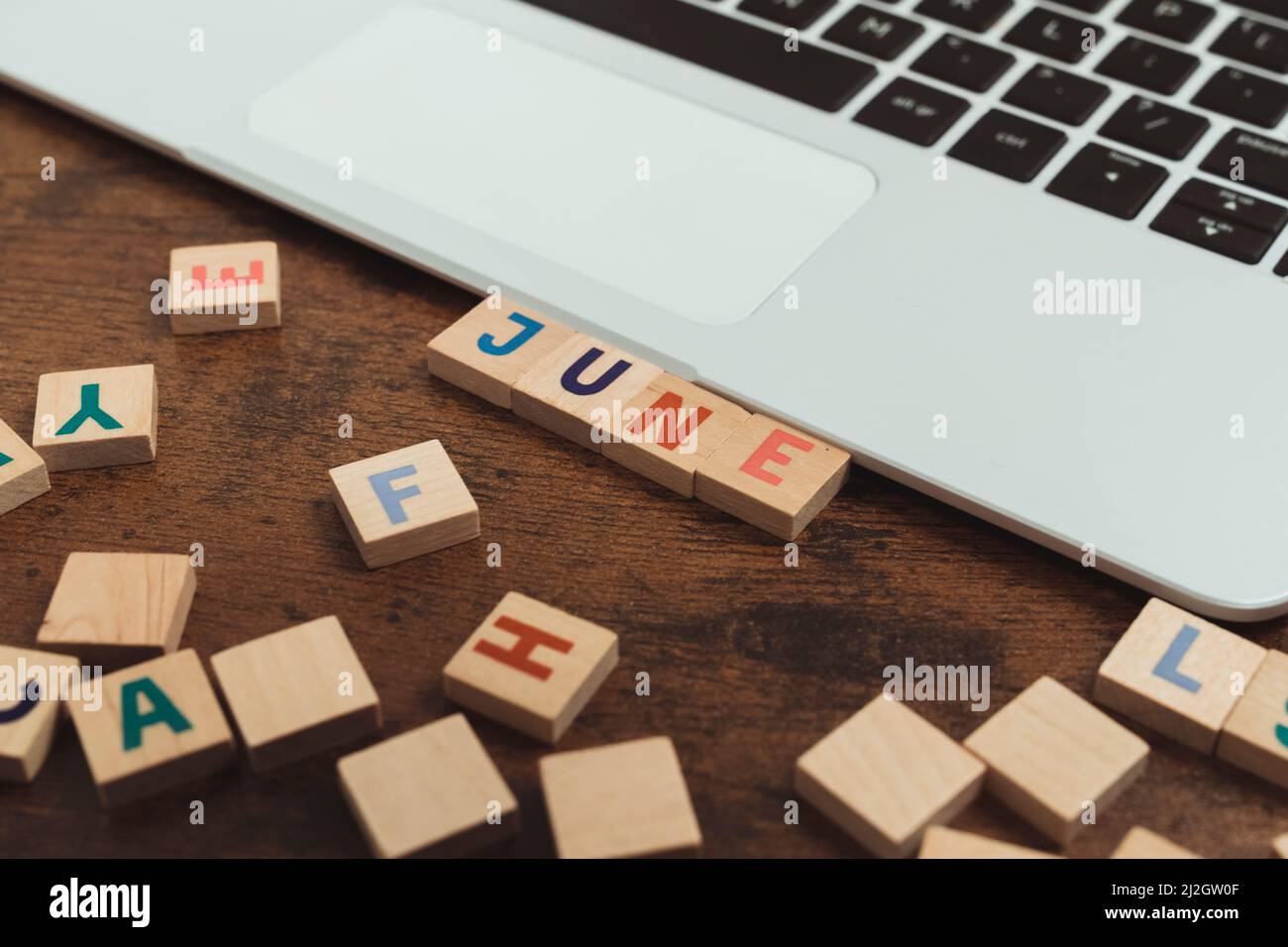 JUNE word made of wooden blocks with alphabet letters vocabulary game ...