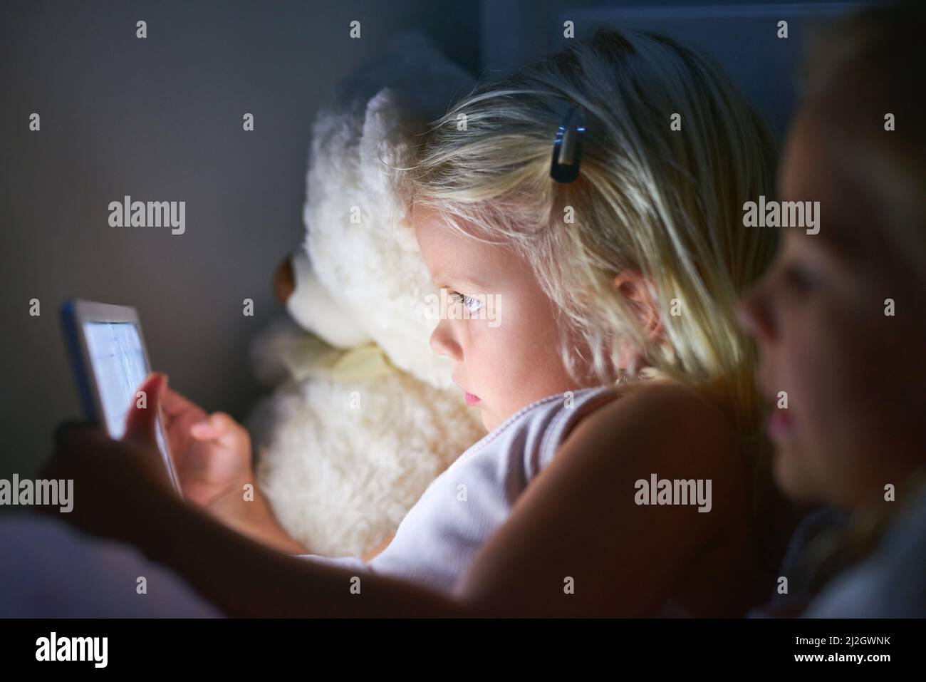 Bedtime has become a lot more interactive. Shot of two little girls ...