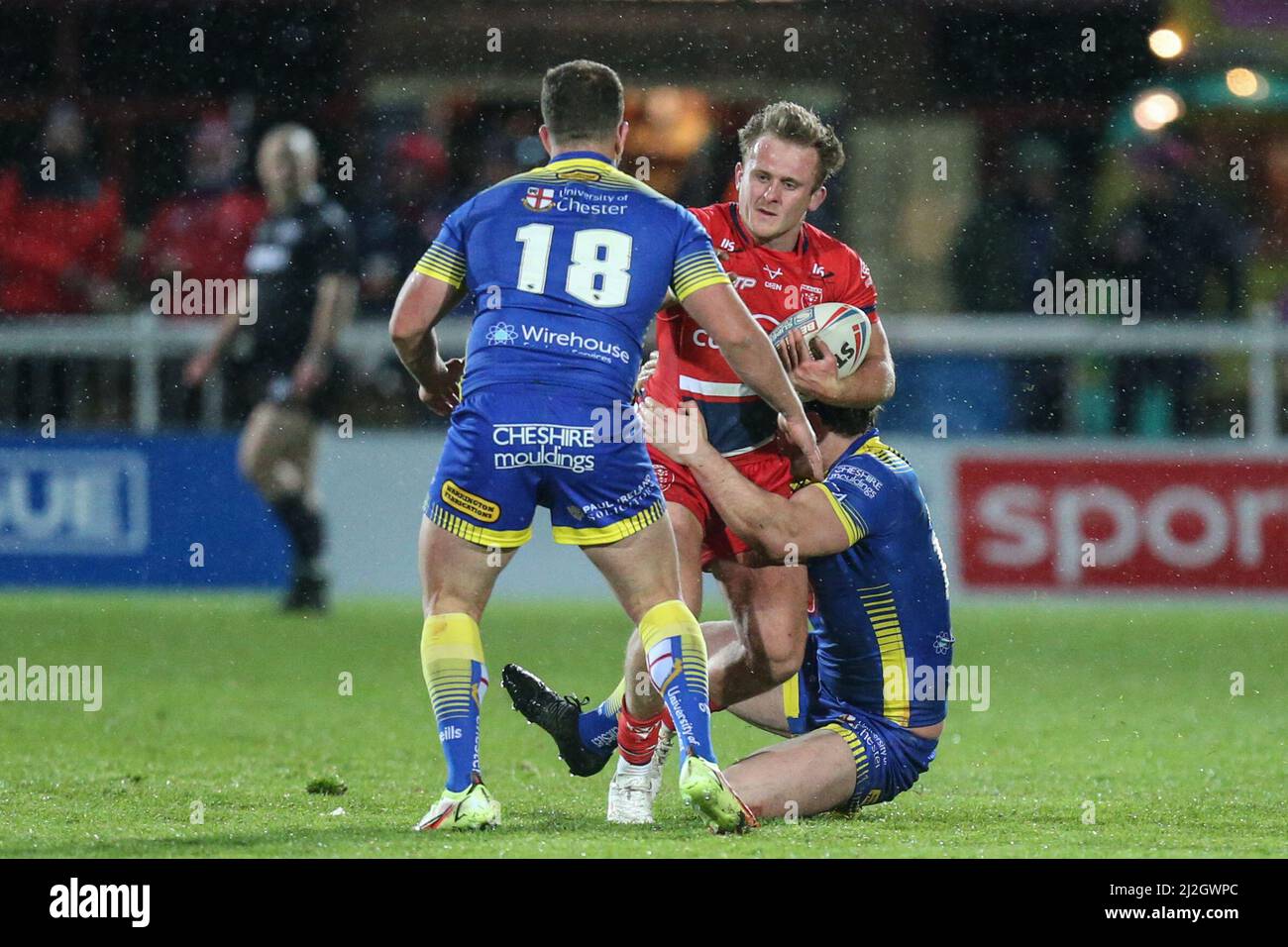Jez Litten #14 of Hull KR is stopped by the Warrington defence Stock ...