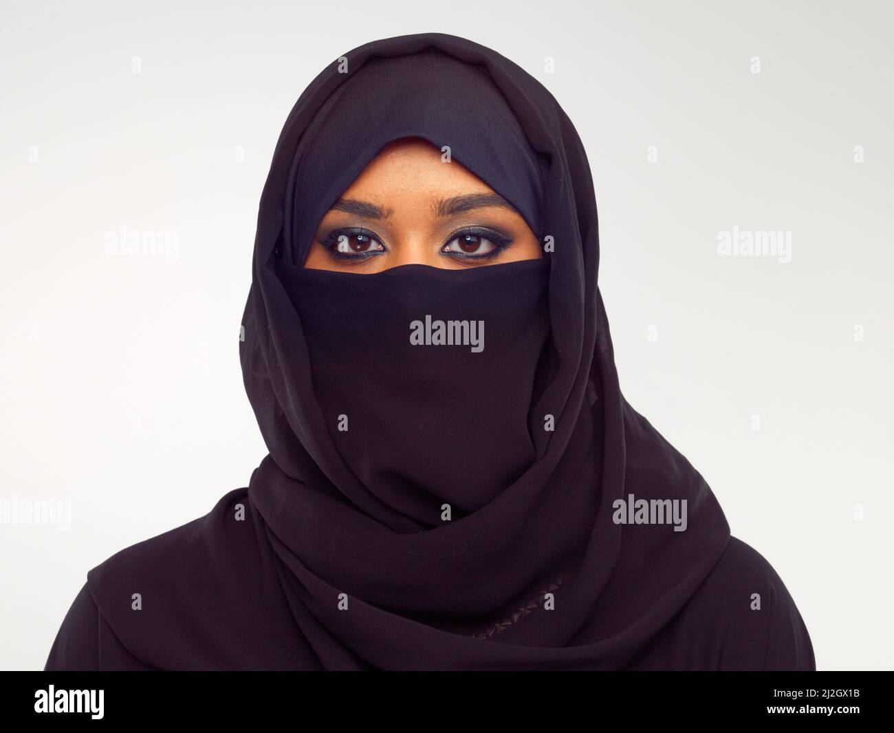 Modesty. Studio portrait of a young muslim woman Stock Photo - Alamy