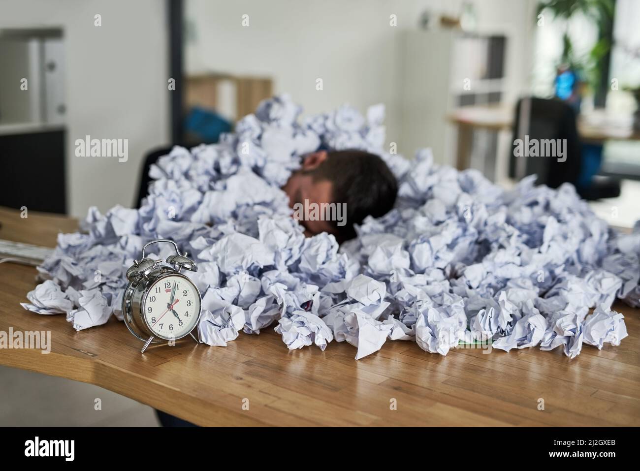 The pressure is weighing heavily. Shot of a young businessman ...
