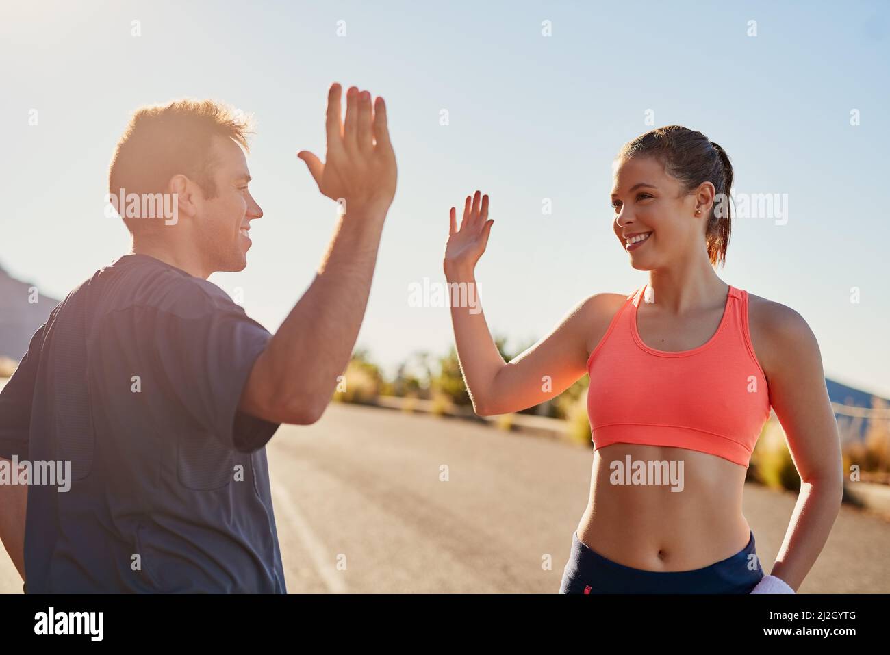 Lets go. Cropped shot of two young people high fiving during their ...