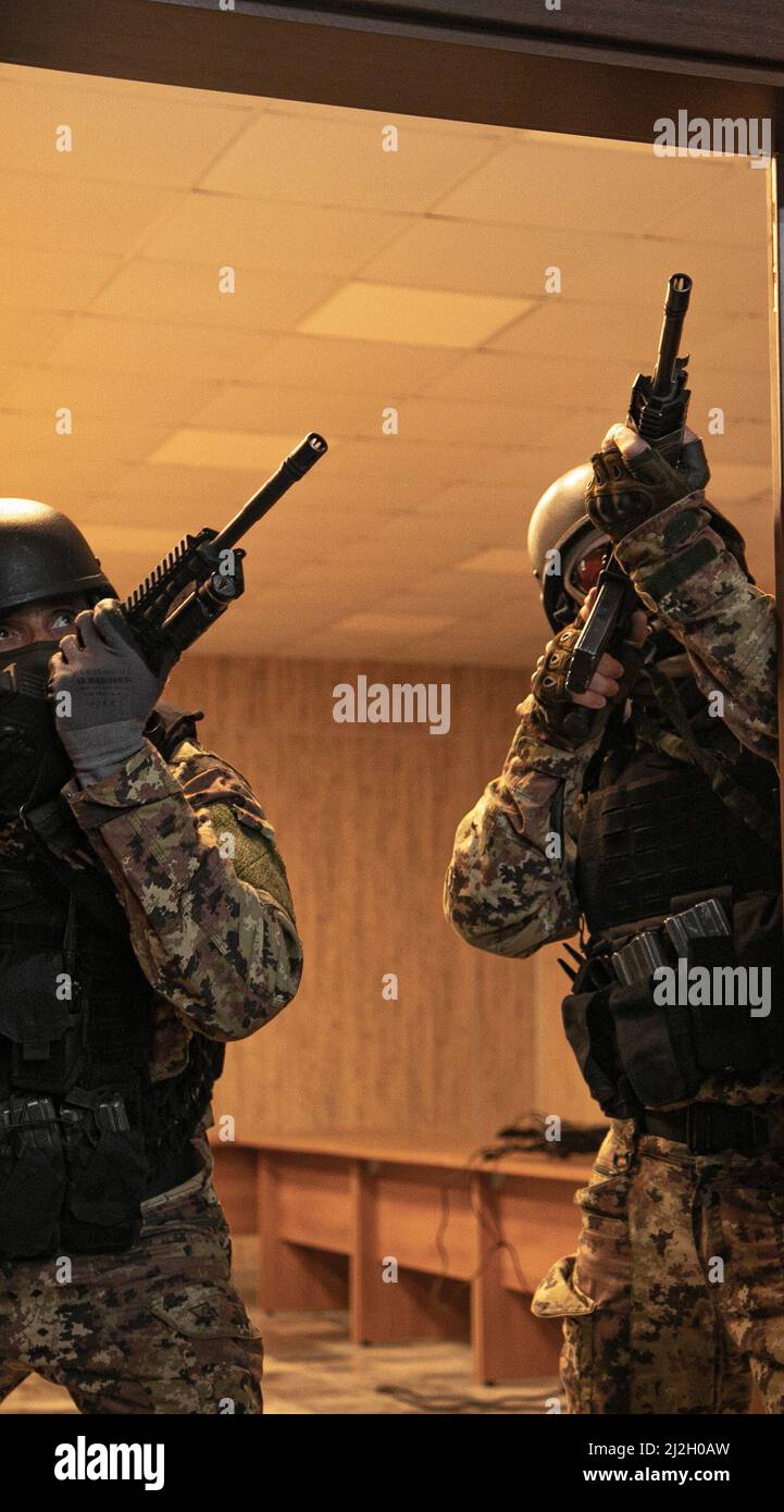 Two members of Kosovo Special Intervention Unit clear a room during a ...