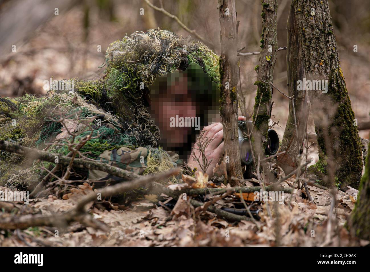 A member of Kosovo Special Intervention Unit lies on the ground showing ...
