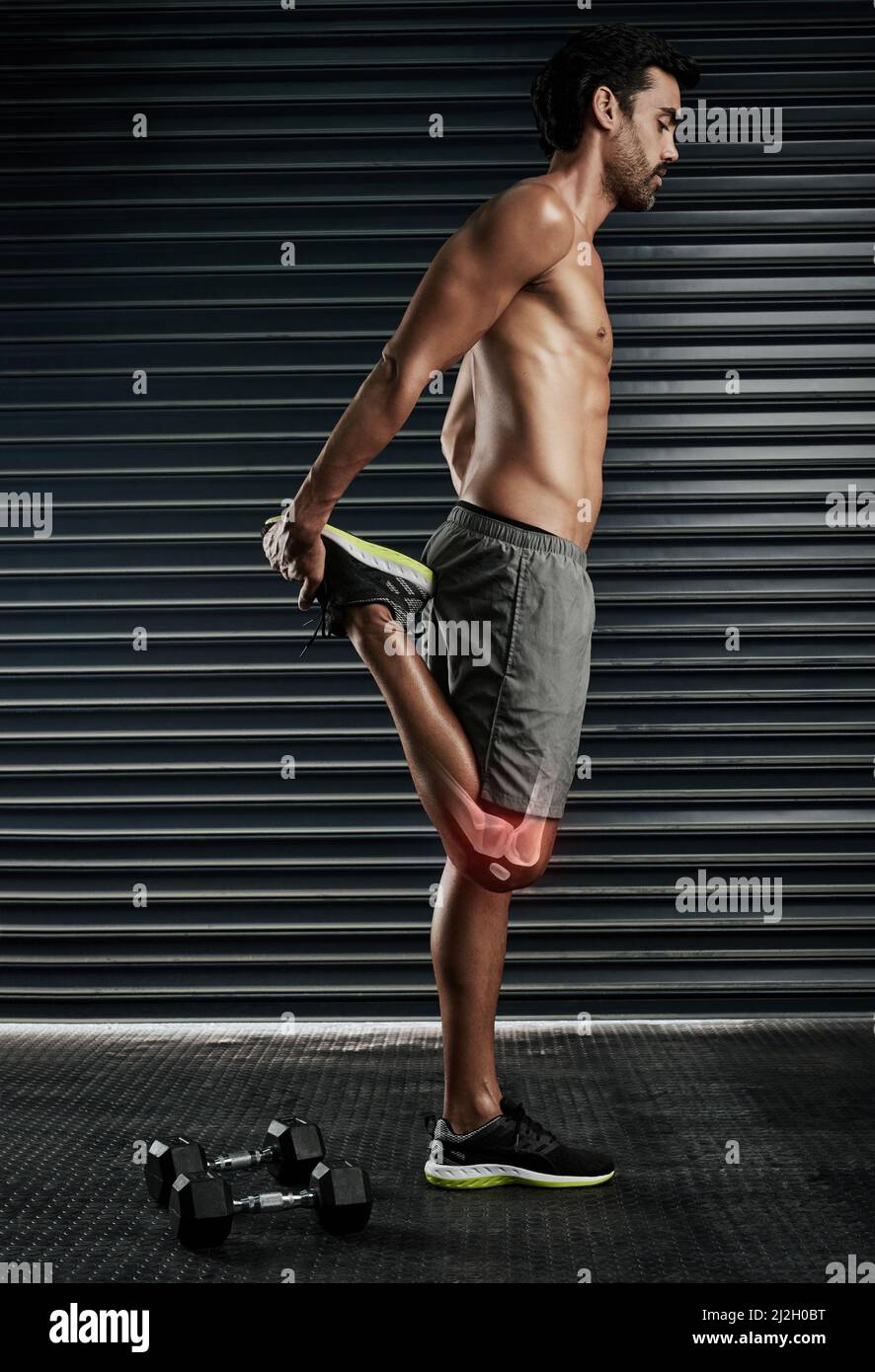 Careful not to over stretch. Studio shot of a muscular young man ...