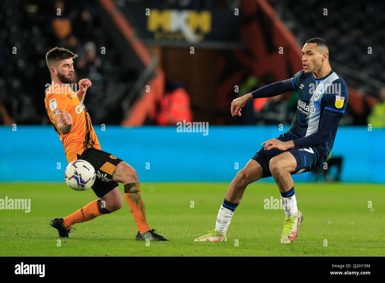 Jon Russell #37 of Huddersfield Town passes the ball past Brandon ...