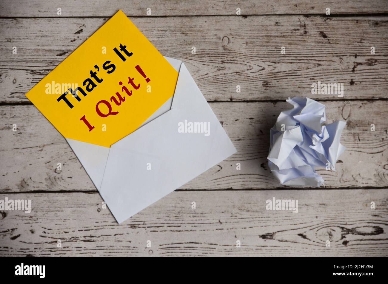 Yellow notepad with text - That's it, I quit with envelope and crumpled ...