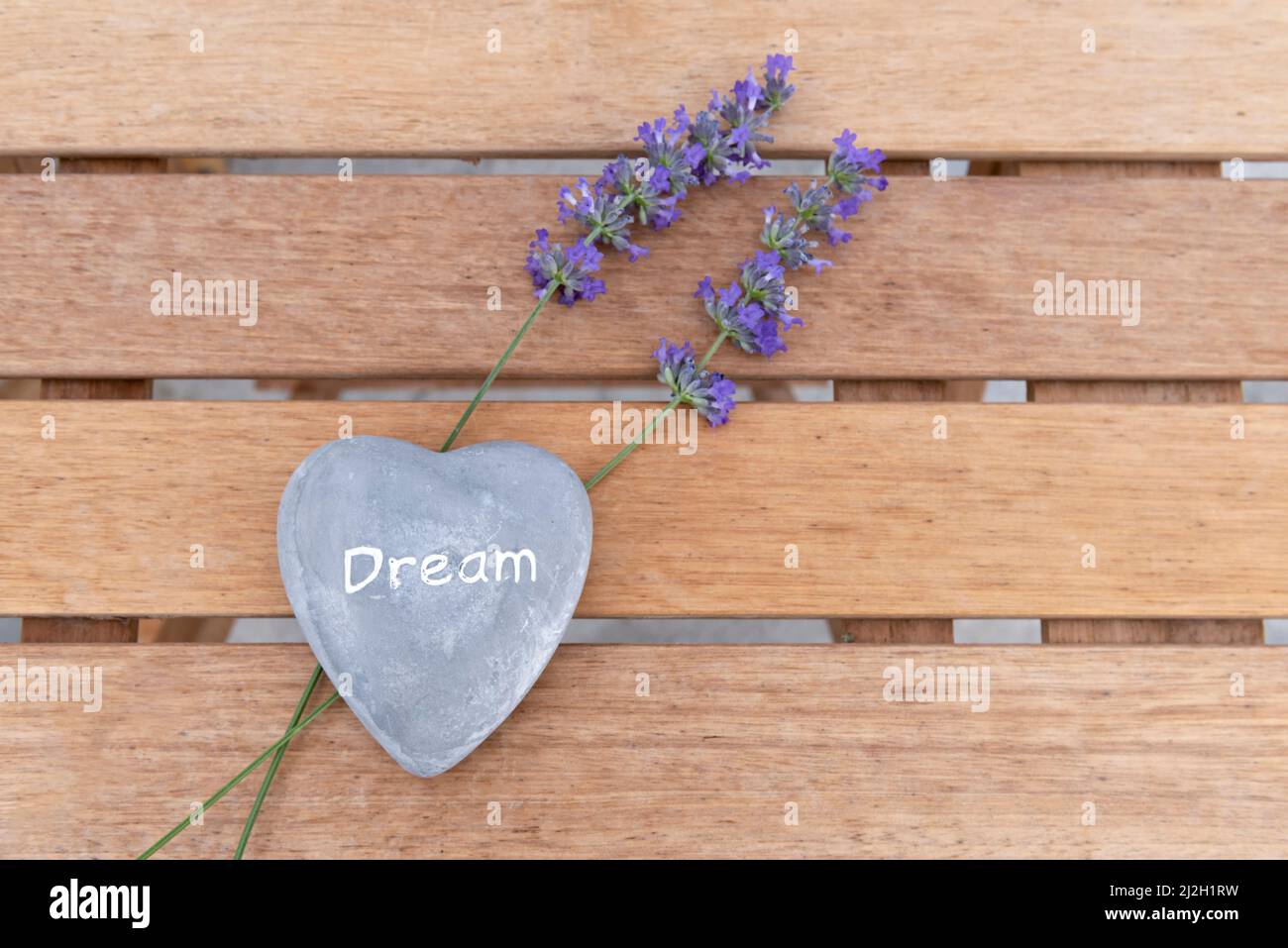 Heart shaped paperweight with flowers on the table Stock Photo - Alamy