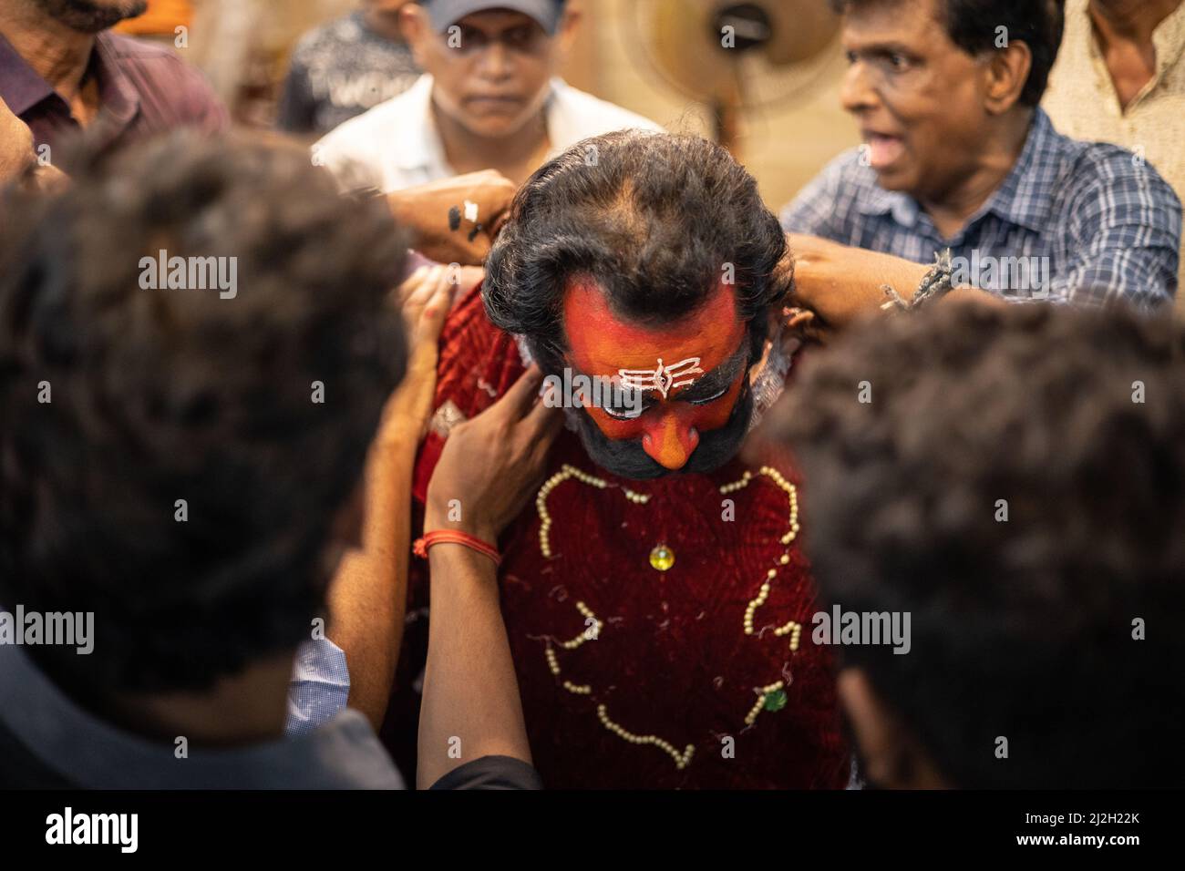 Men helping to dress up Virabhadra for the folk dance performance at ...