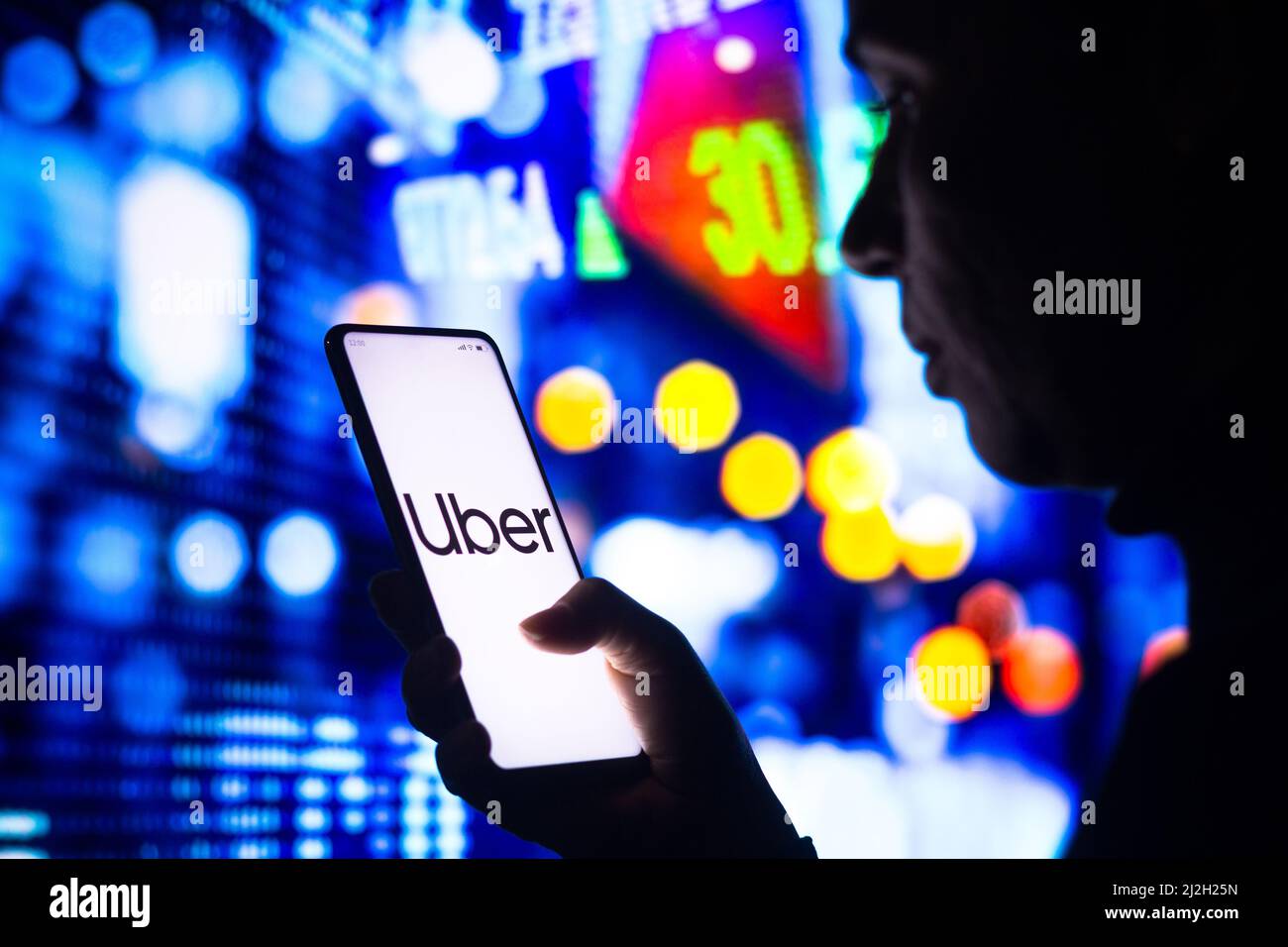 In this photo illustration, a woman's silhouette holds a smartphone ...