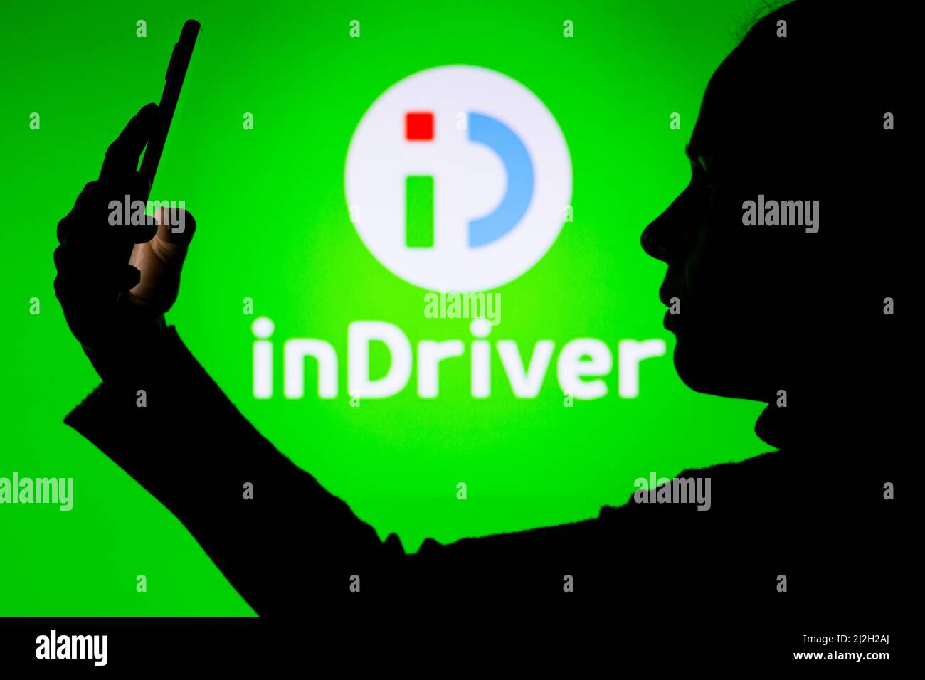 In this photo illustration, a woman's silhouette holds a smartphone ...