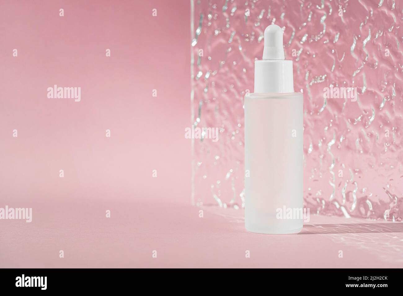 Transparent liquid product in glass bottle. Anti aging serum with ...