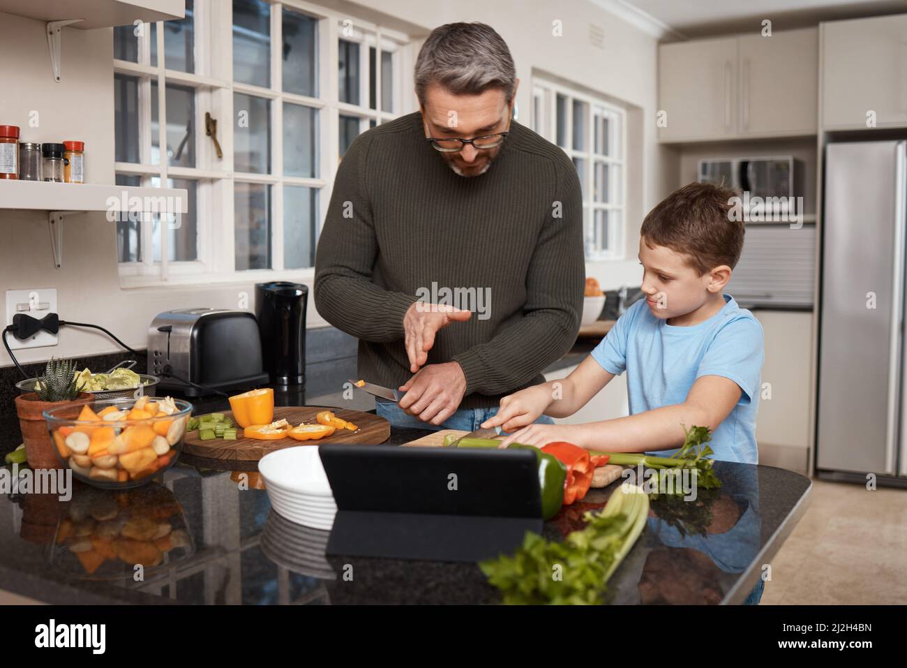Son helping father cook hi-res stock photography and images - Alamy
