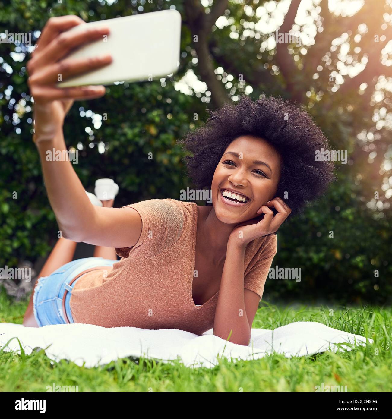 Nature makes for the best background in selfies. Shot of a young woman ...
