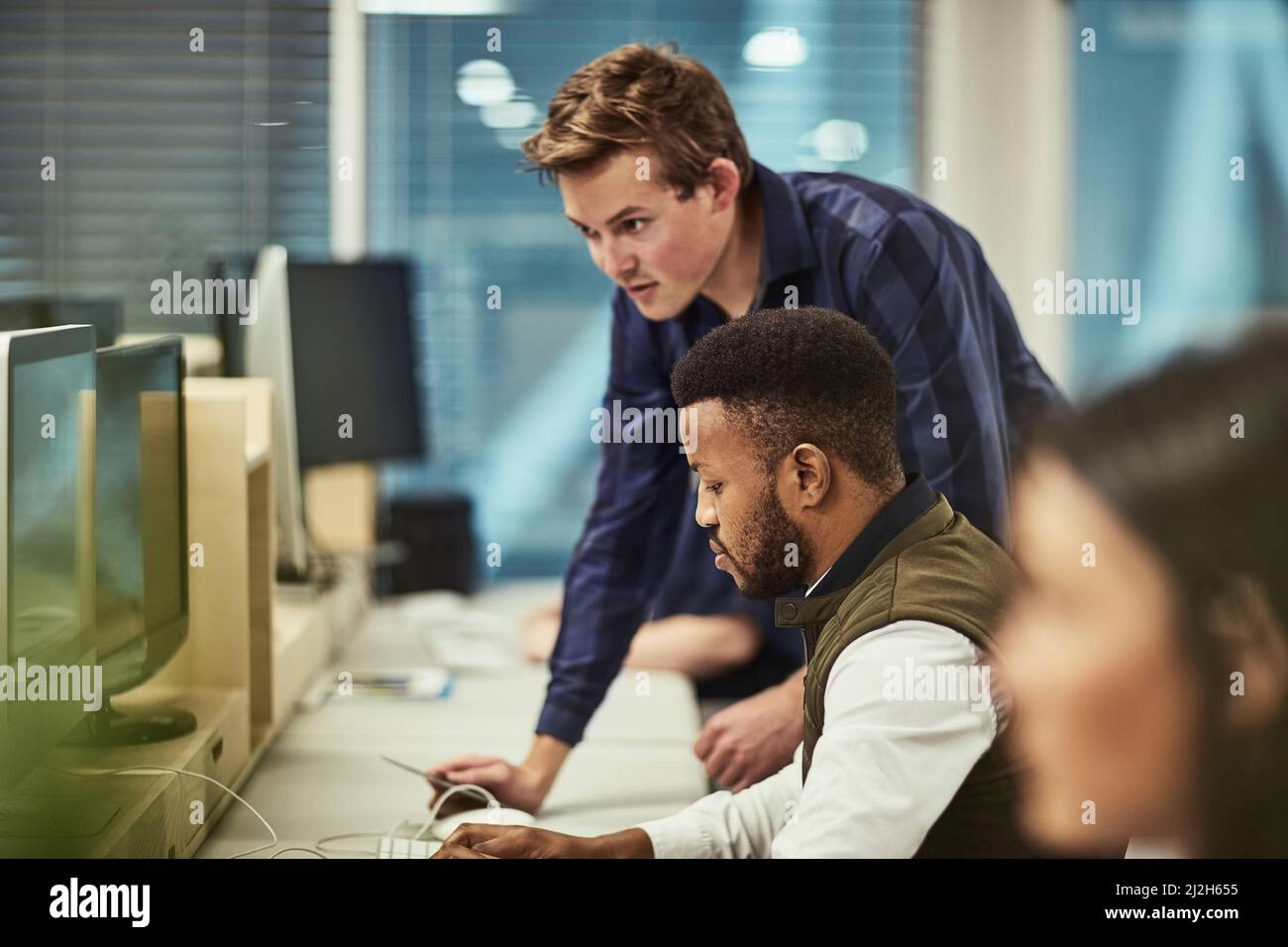 Tackling tasks together to get ahead. Shot of a group of designers ...