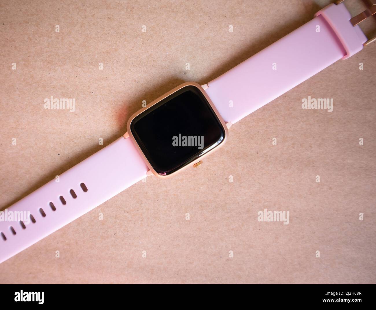 Wireless Smart Watch with Pink Strap Isolated on Brown kraft Paper ...