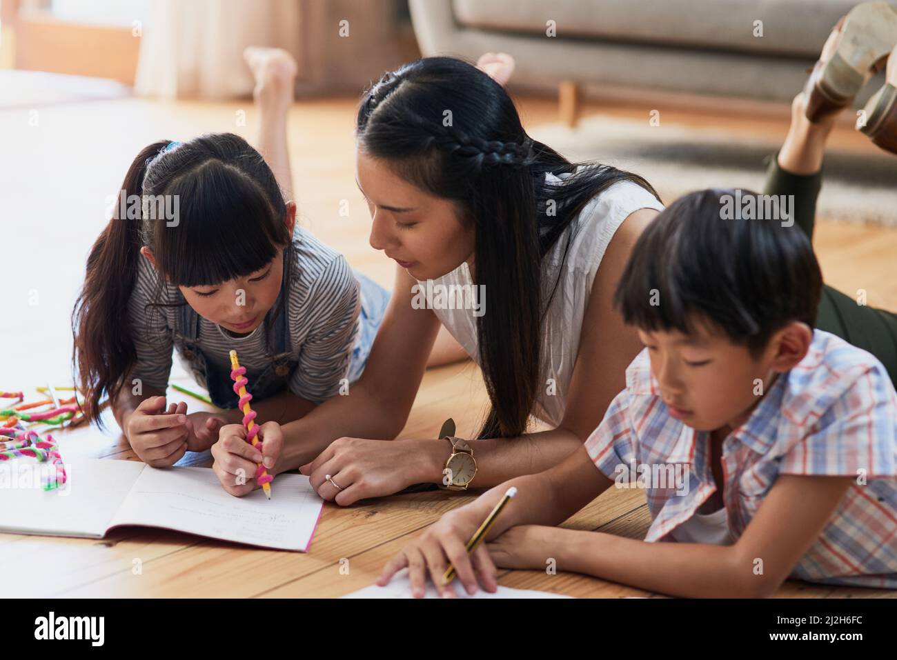This is how its done my dear. Shot of a cheerful mother and her two ...