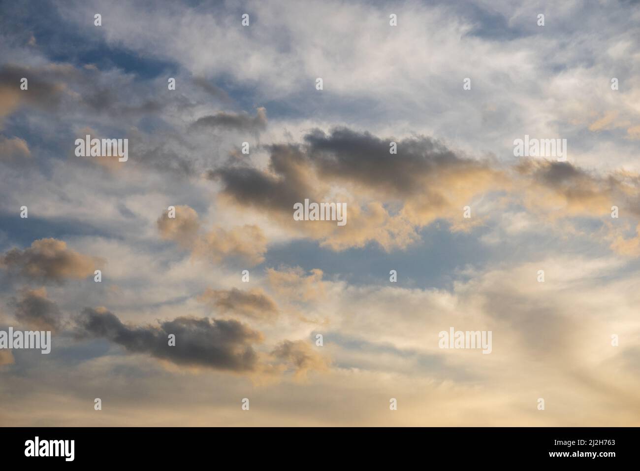 Beautiful pre-sunset clouds with bits of blue sky Stock Photo - Alamy