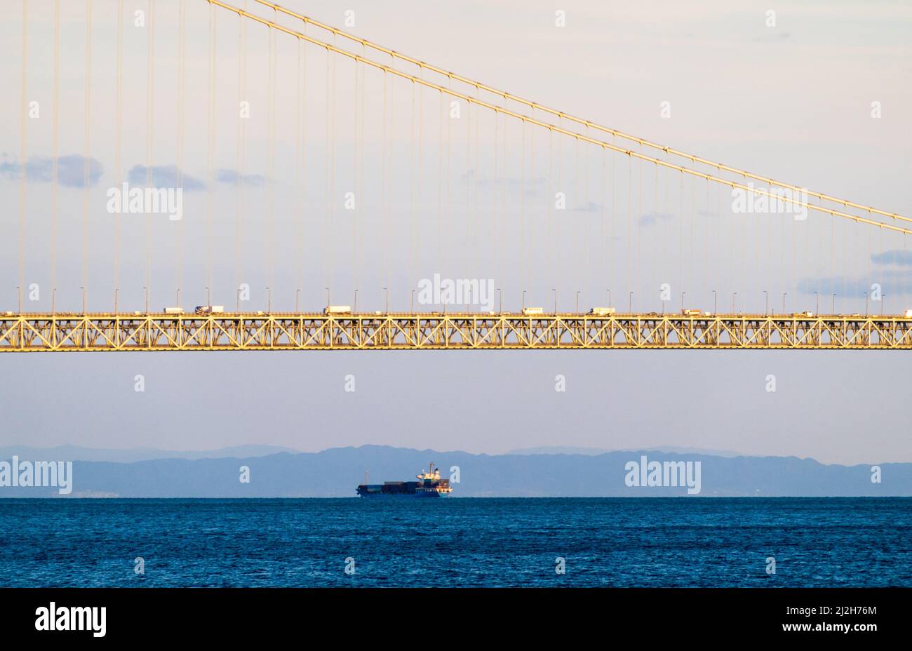 Container ship under bridge carrying cargo trucks Stock Photo - Alamy