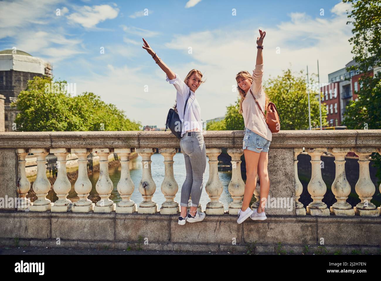 Freedom in a foreign city. Rearview portrait of two attractive young ...