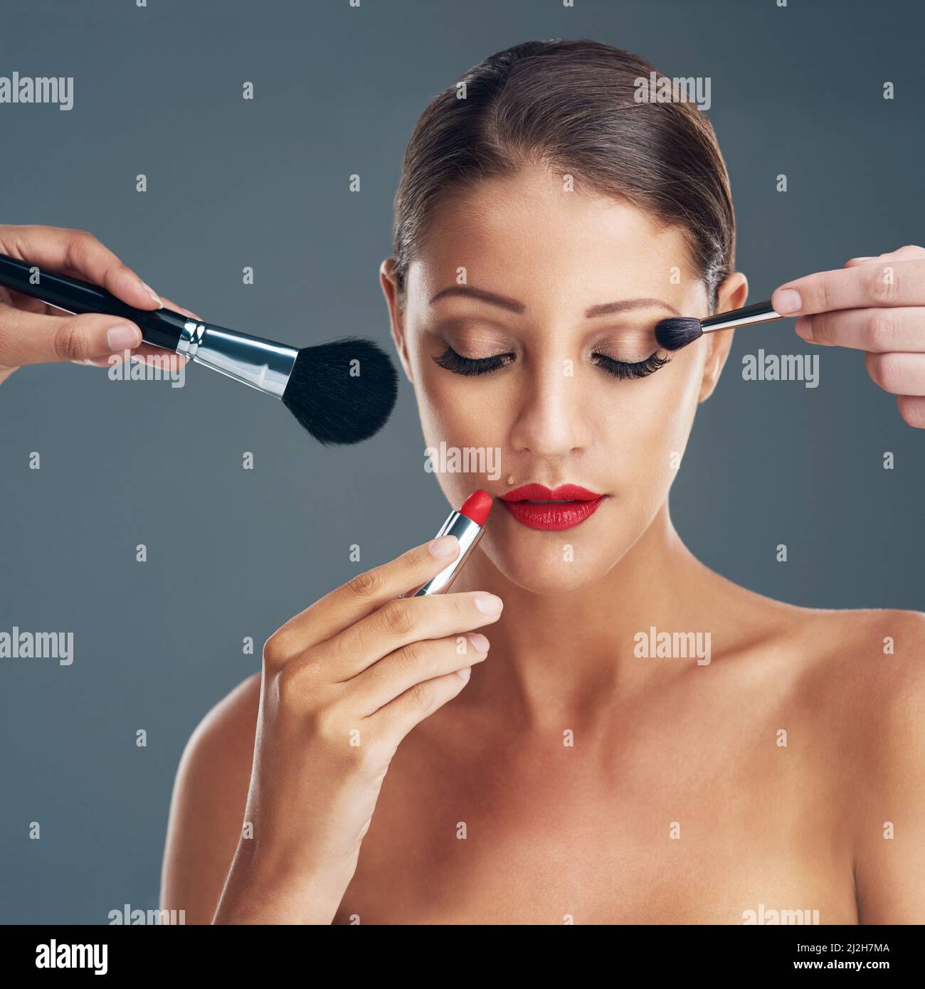 Studio makeup process hands with brush hi-res stock photography and ...