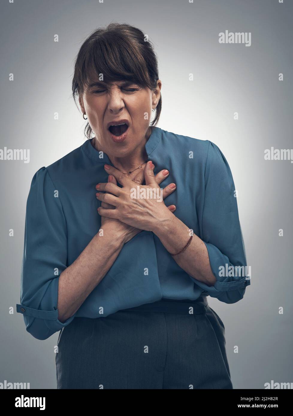Woman touching her chest hi-res stock photography and images - Alamy