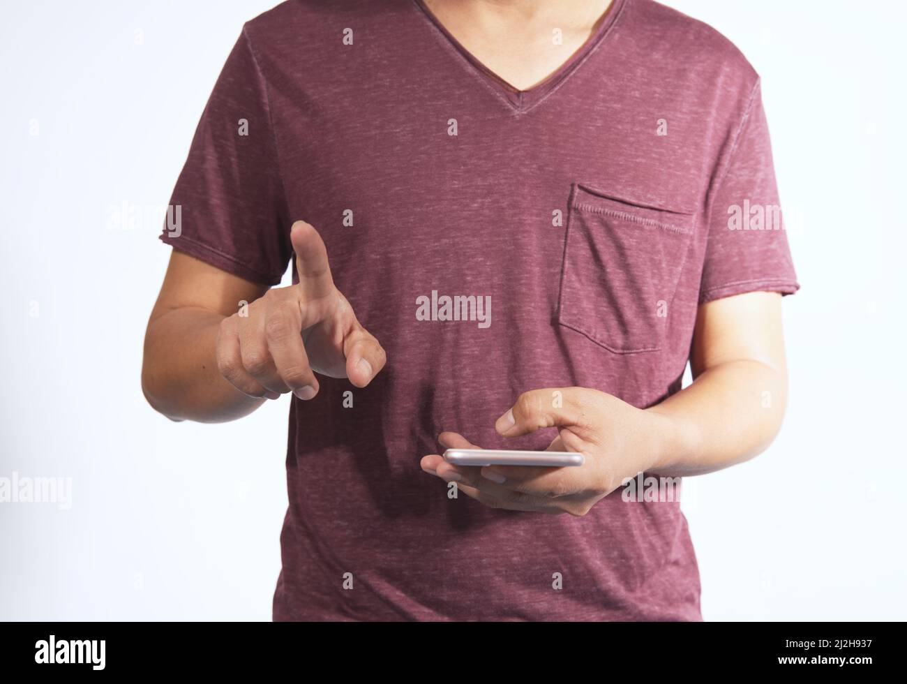 a tall man standing happily using a smartphone On a white isolated ...