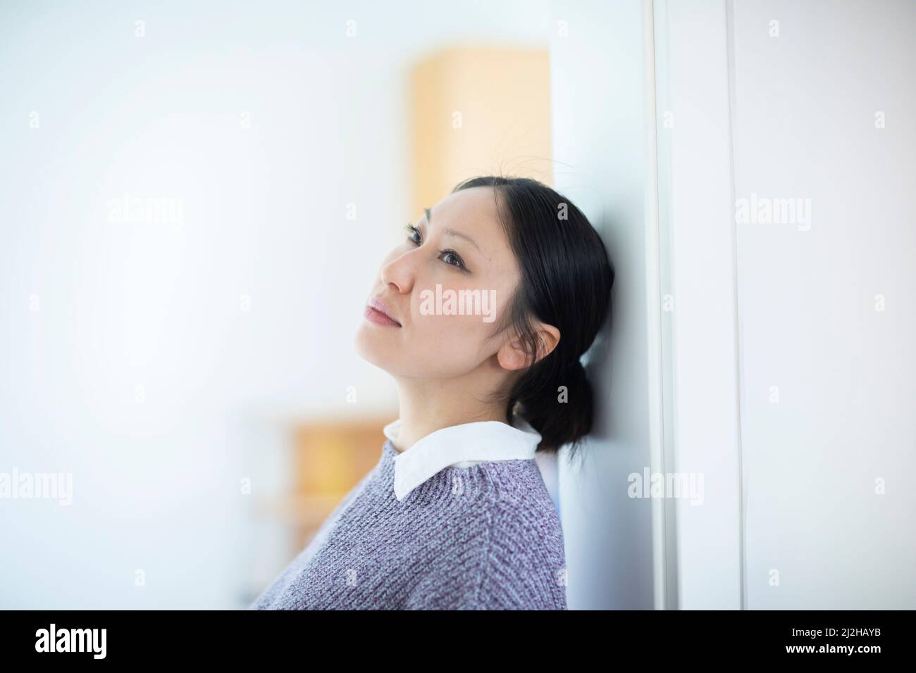 Pensive woman at home Stock Photo - Alamy
