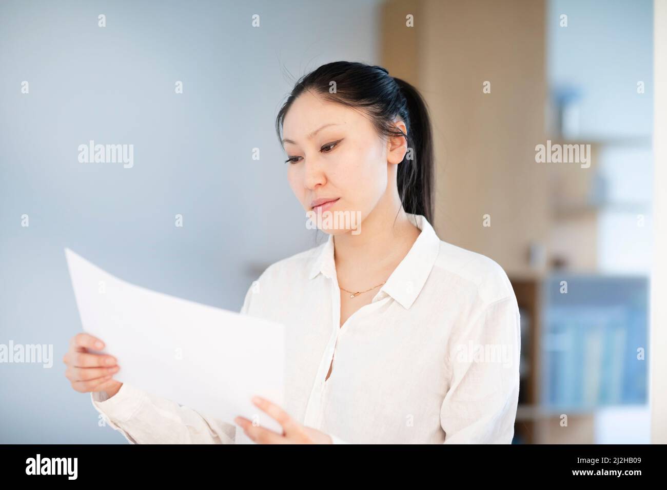 Serious businesswoman looking documents hi-res stock photography and ...