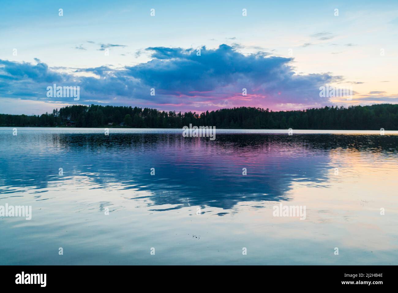 Lake reflecting clouds at sunset Stock Photo - Alamy
