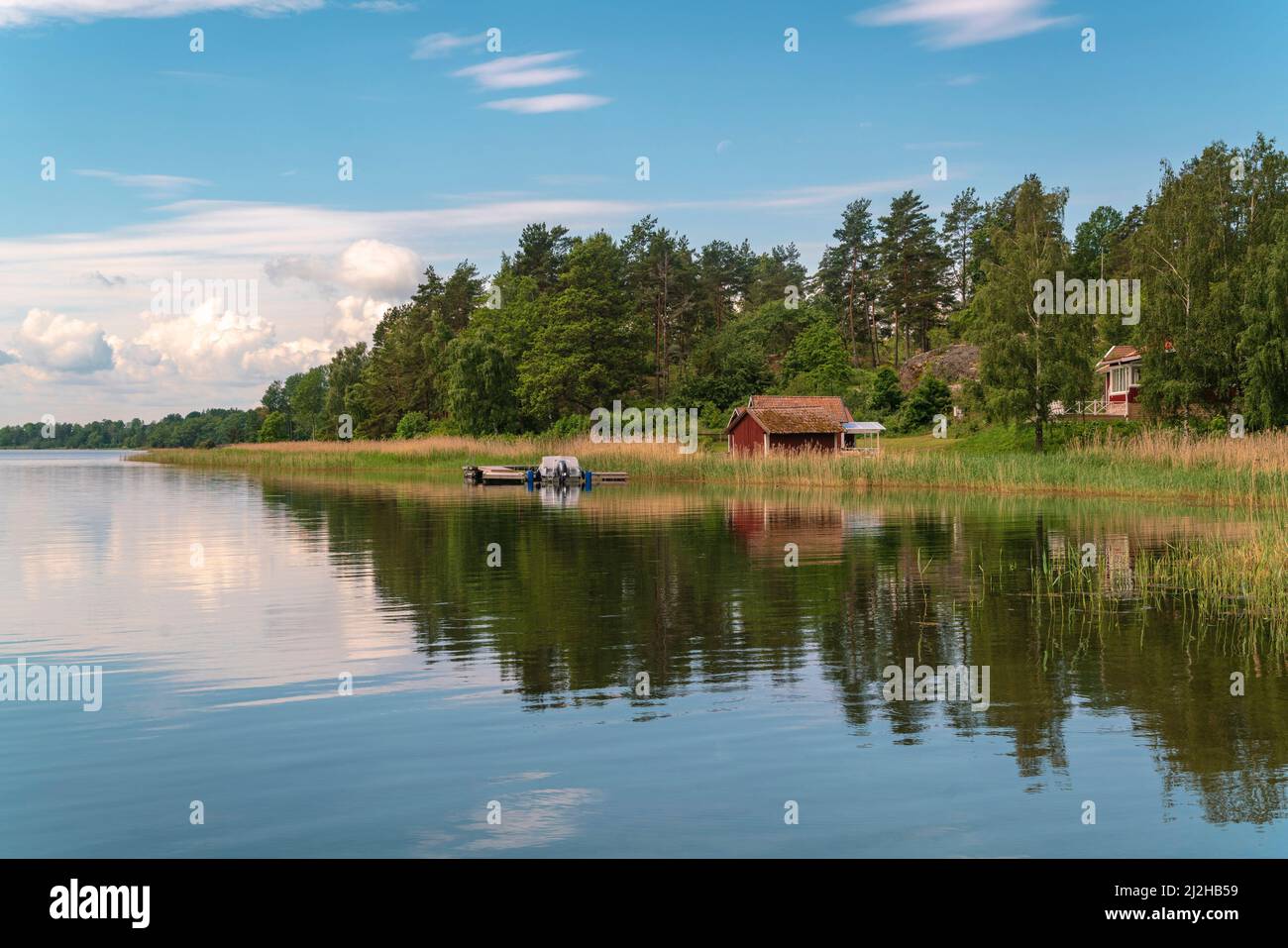 Sweden, Loftahammar, Small house on grassy coast Stock Photo - Alamy