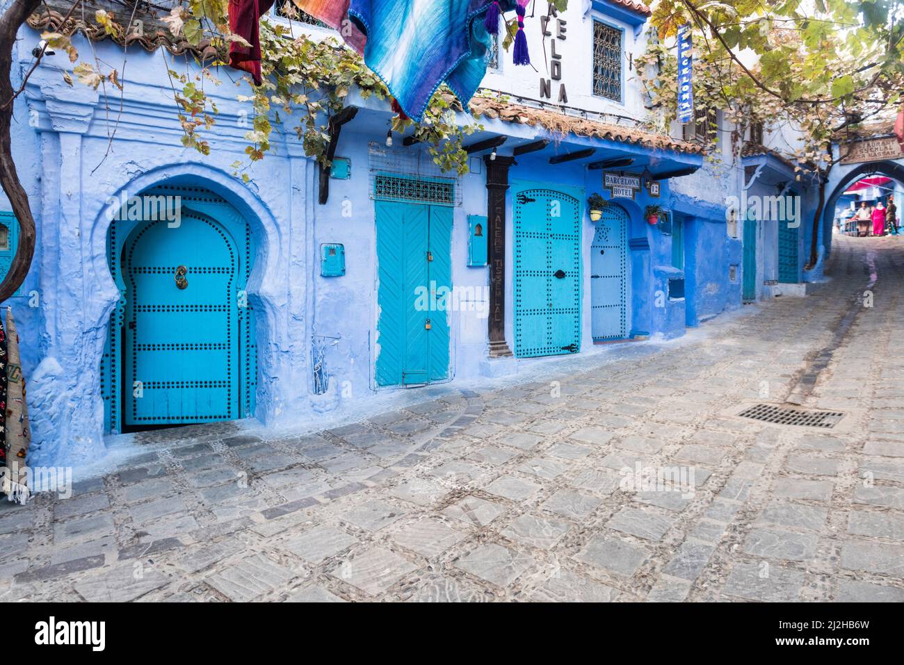Morocco, Chefchaouen, Cobblestone alley and traditional blue houses ...