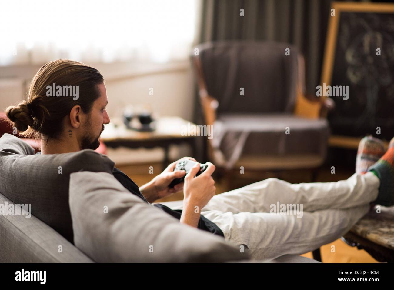 Man playing video game at home Stock Photo - Alamy