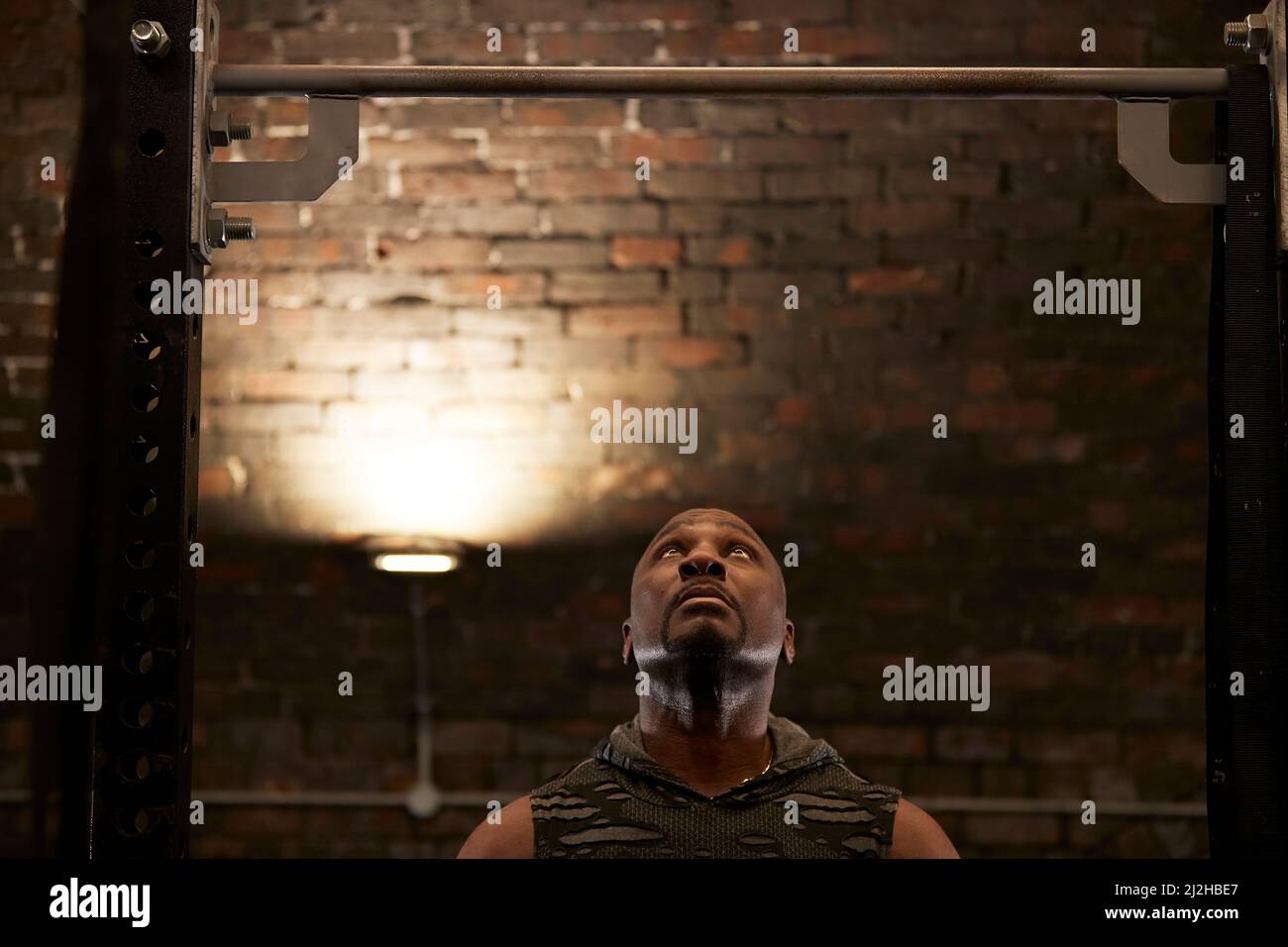 Muscular man looking up in gym Stock Photo - Alamy