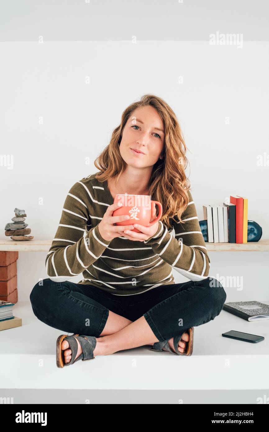 Woman sitting cross legged on hi-res stock photography and images - Alamy