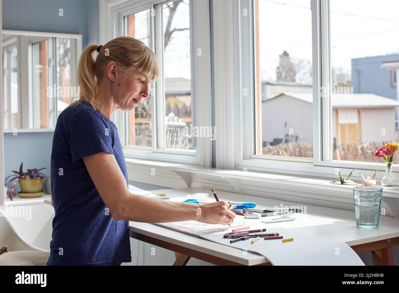 Mature woman drawing at home Stock Photo - Alamy